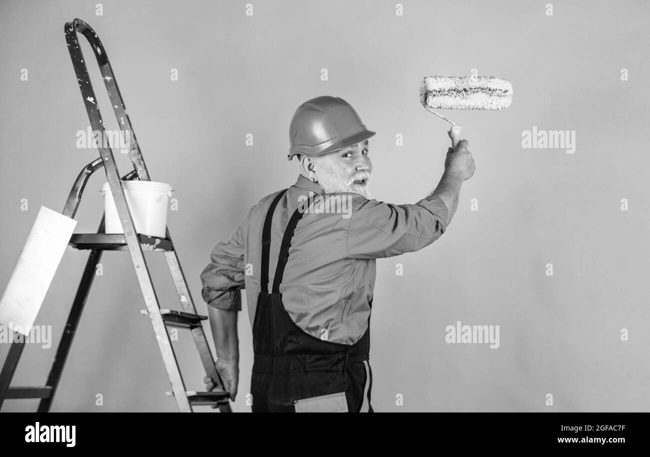 Assistant. Craftsman With Paint Roller. House Painting and Renovation ...