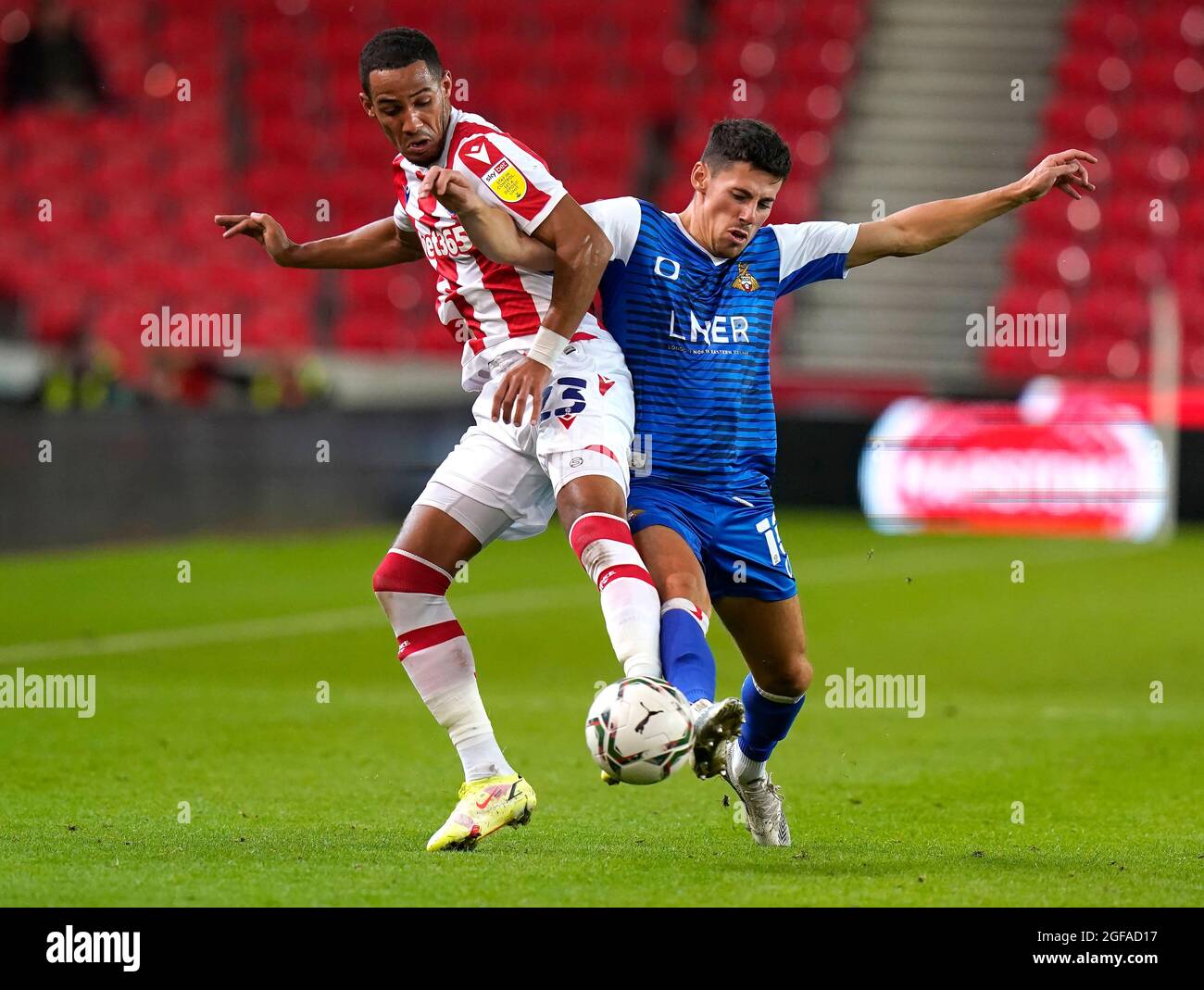 Stoke, UK. 24th Aug, 2021. Thomas Ince of Stoke City (L) vies with Ed ...