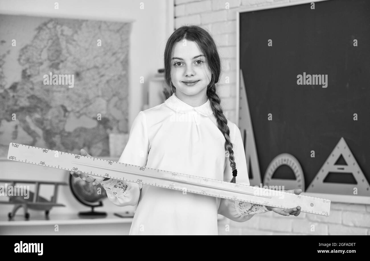 Education and university. School girl hold ruler. Instrument of ...