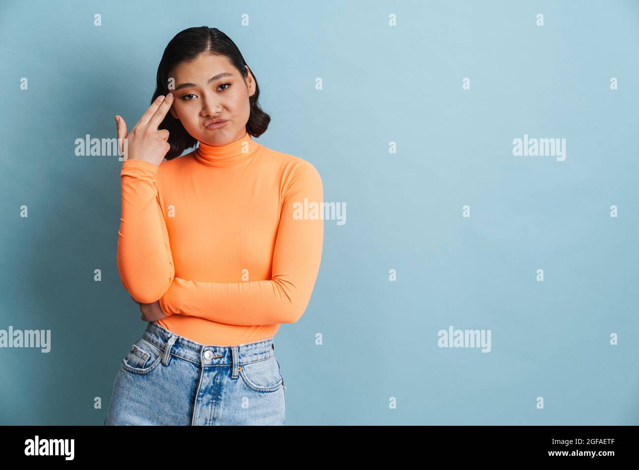 Portrait of a confused frowning casual brunette young asian woman ...