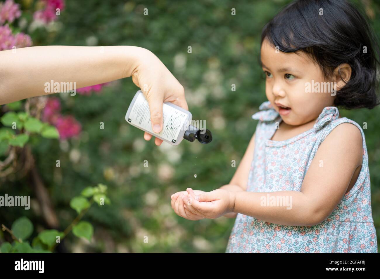 Closeup shot of a cute South Asian child cleaning hands Stock Photo - Alamy