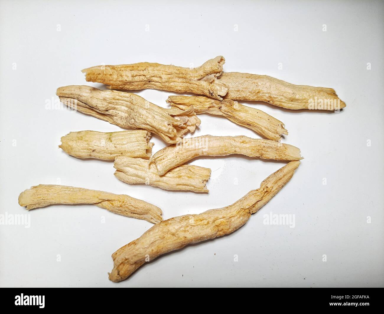 Closeup of dried rat tailed radish on a white background Stock Photo ...