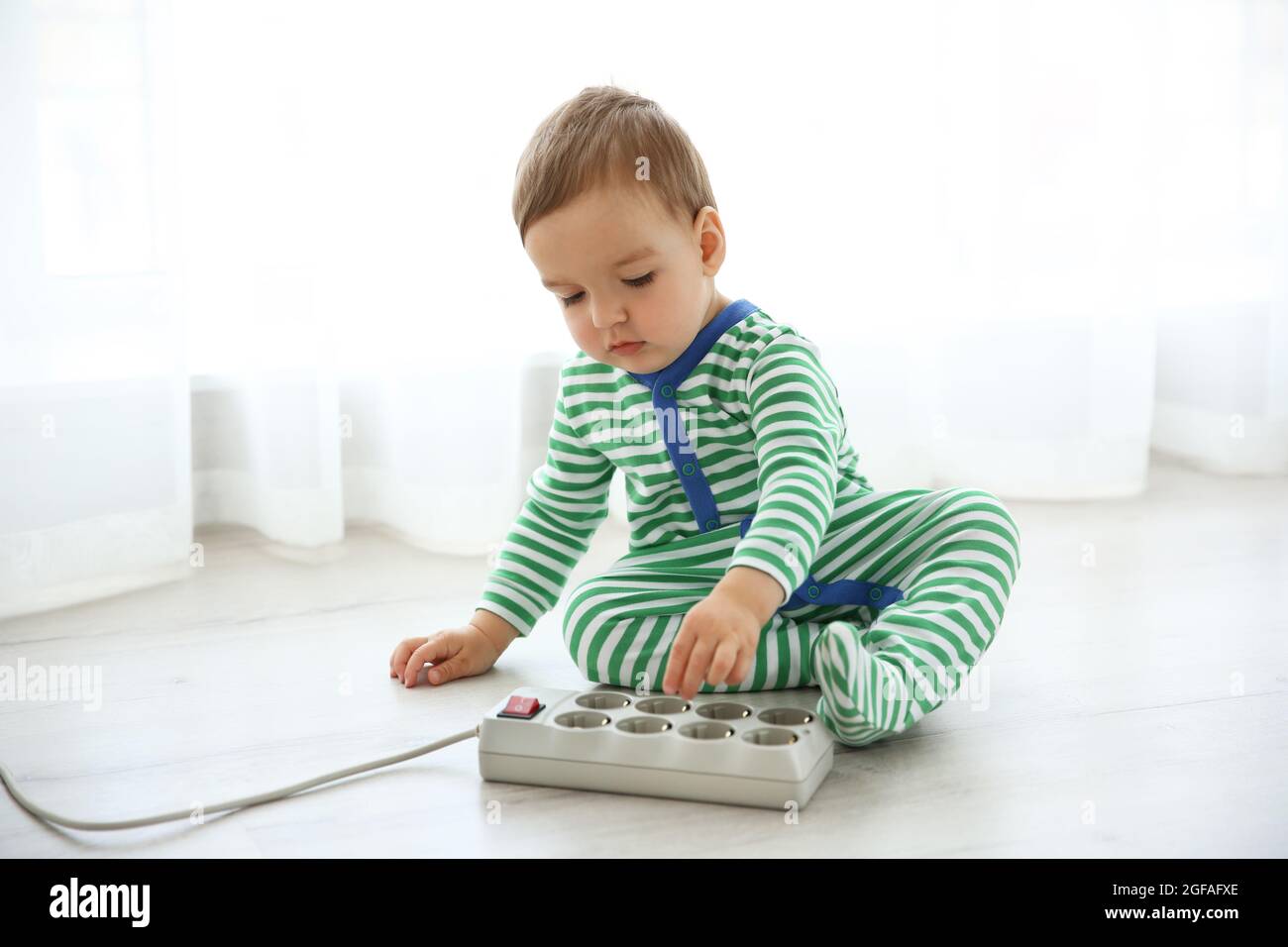 Little baby playing with electric power bar Stock Photo - Alamy