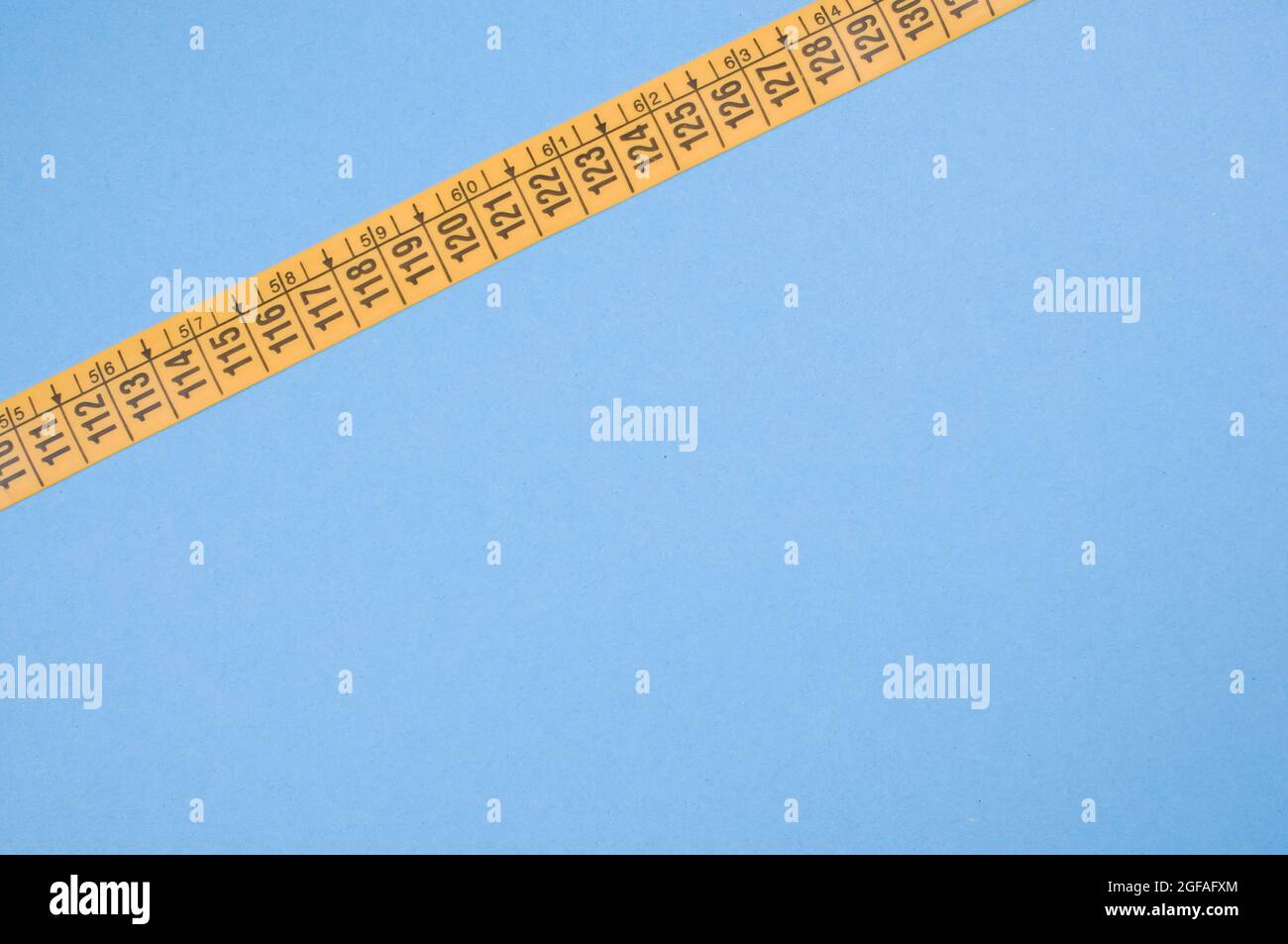 Top view of a roll meter on a yellow background Stock Photo - Alamy