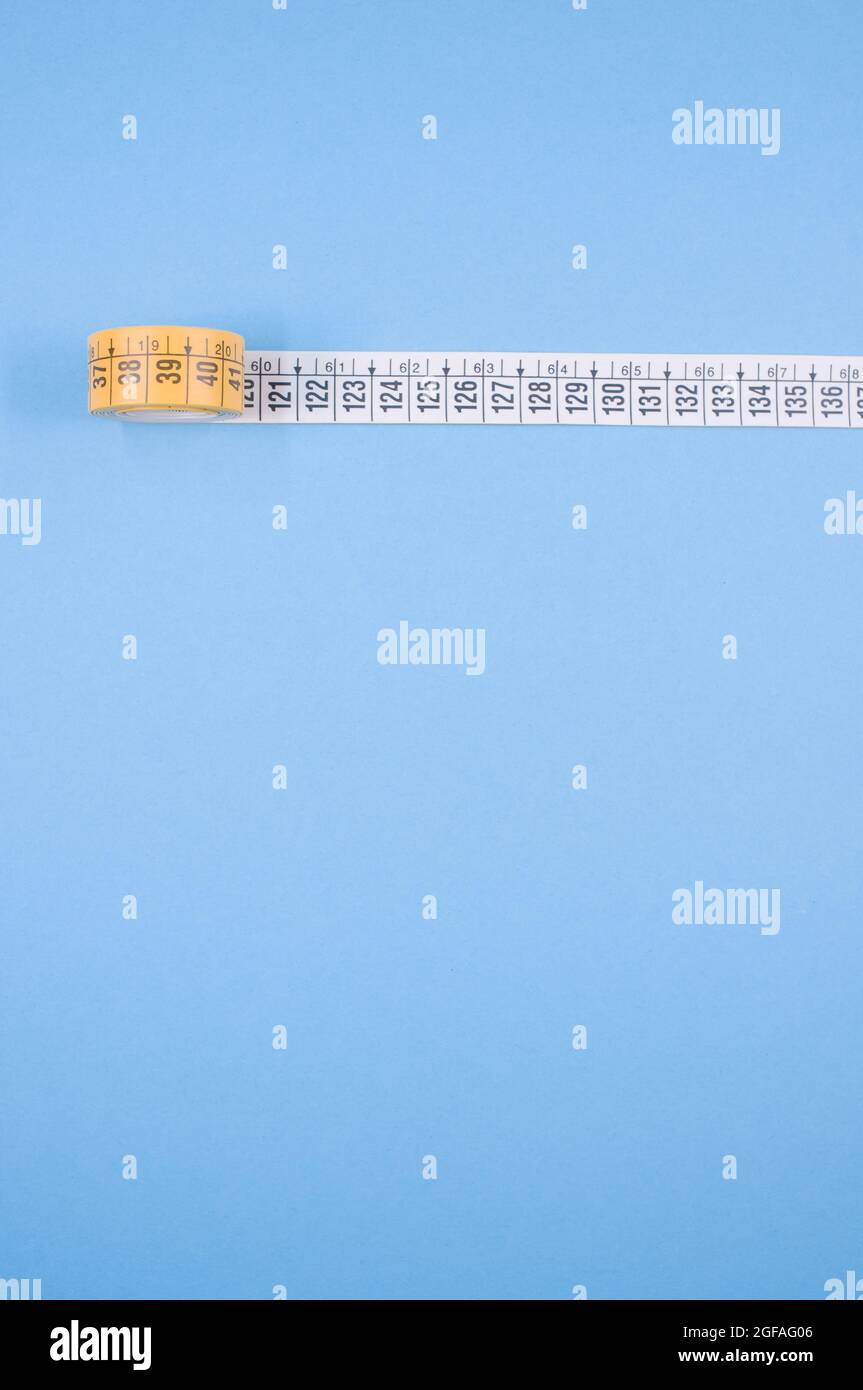 Top view of a roll meter on a yellow background Stock Photo - Alamy