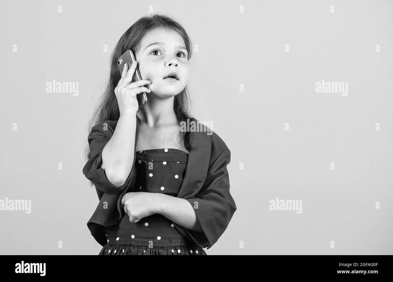 Nice talk. Happy childhood. Small child with smartphone. Cheerful ...