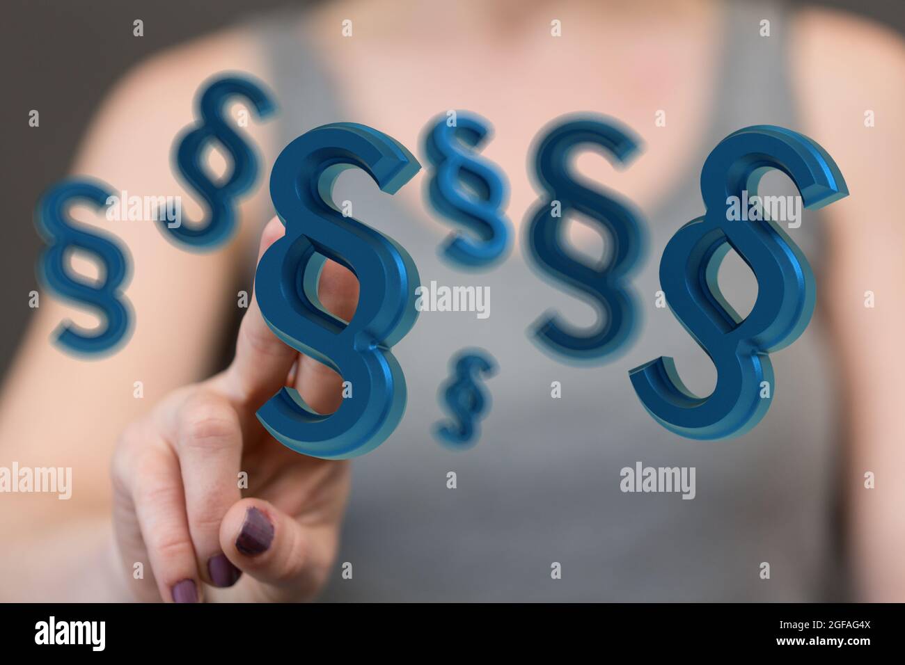 Lawyer's hand selecting from a 3D render of floating law and justice ...