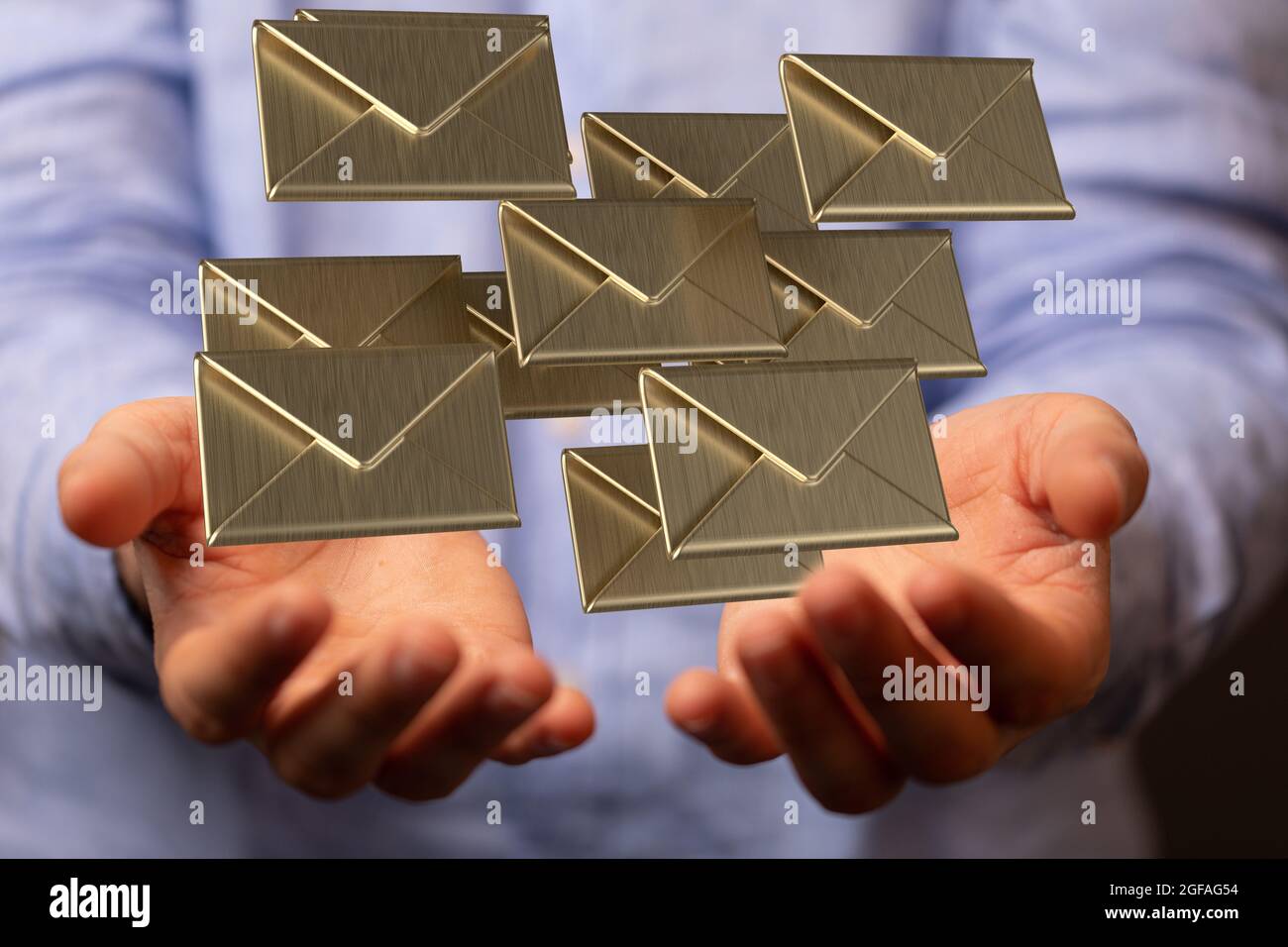 Businessman holding a 3D render of floating gold communication icons ...