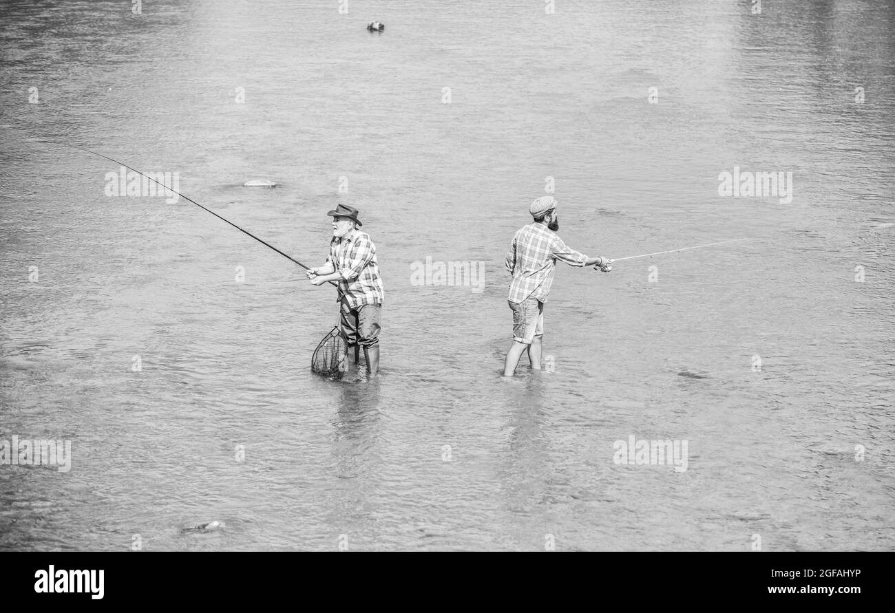 deep in water. hobby and sport activity. Trout bait. two happy ...