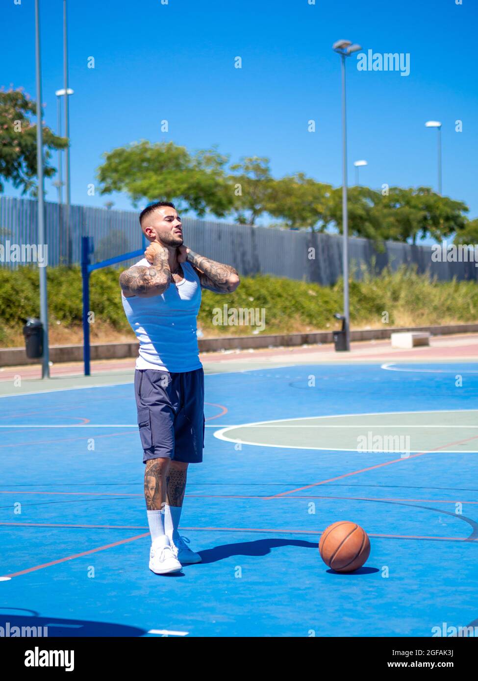 Athletic handsome Spanish basketball player training on a basketball ...