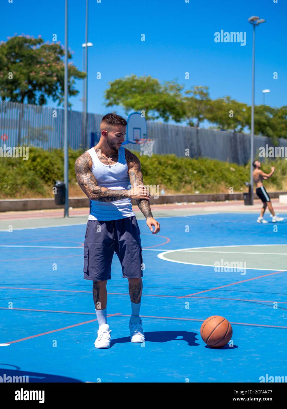 Athletic handsome Spanish basketball player training on a basketball ...