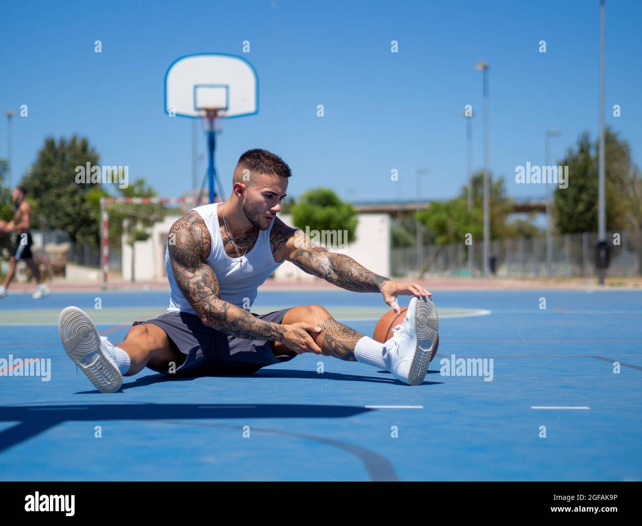 Athletic handsome Spanish basketball player training on a basketball ...