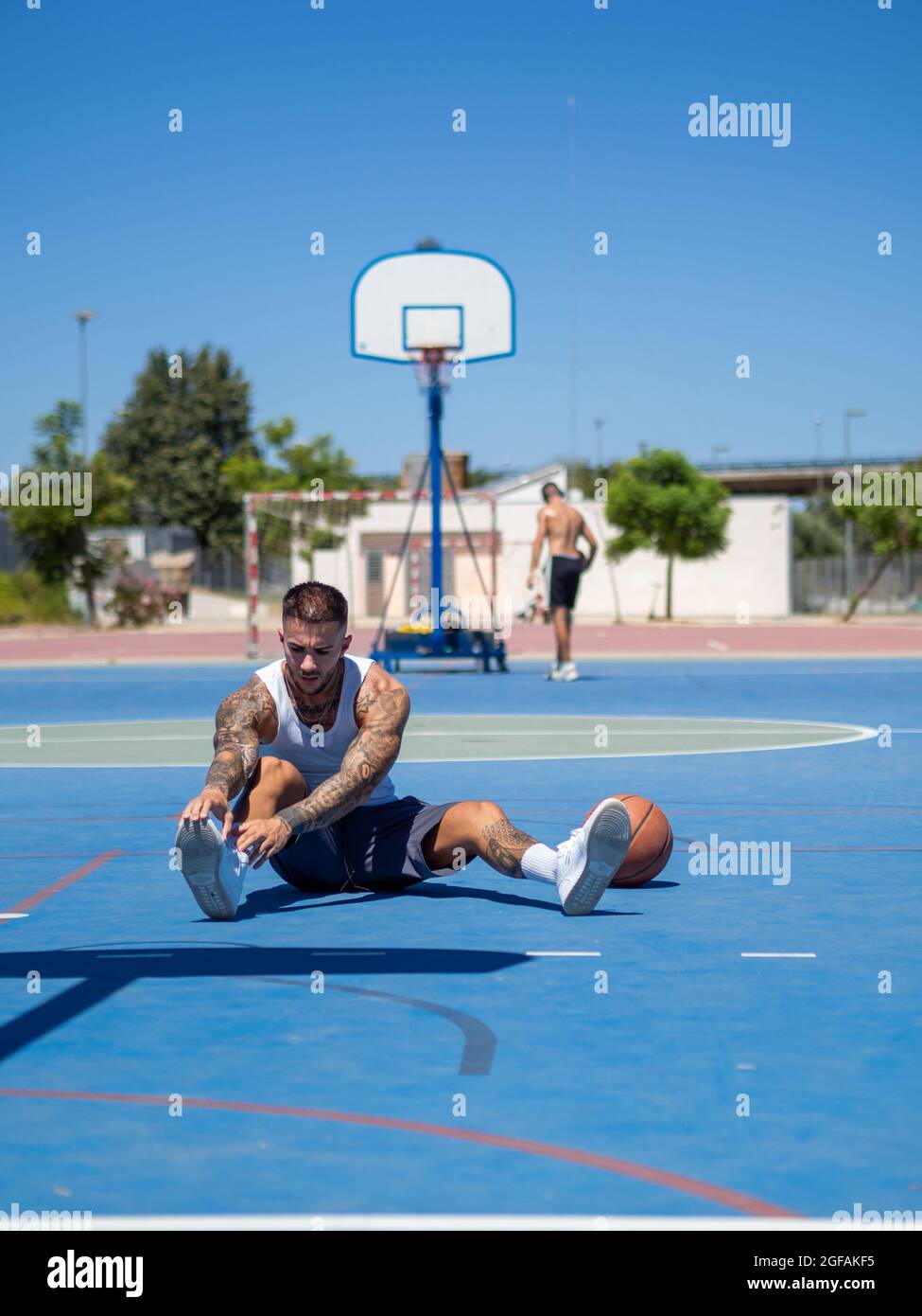 Athletic handsome Spanish basketball player training on basketball ...