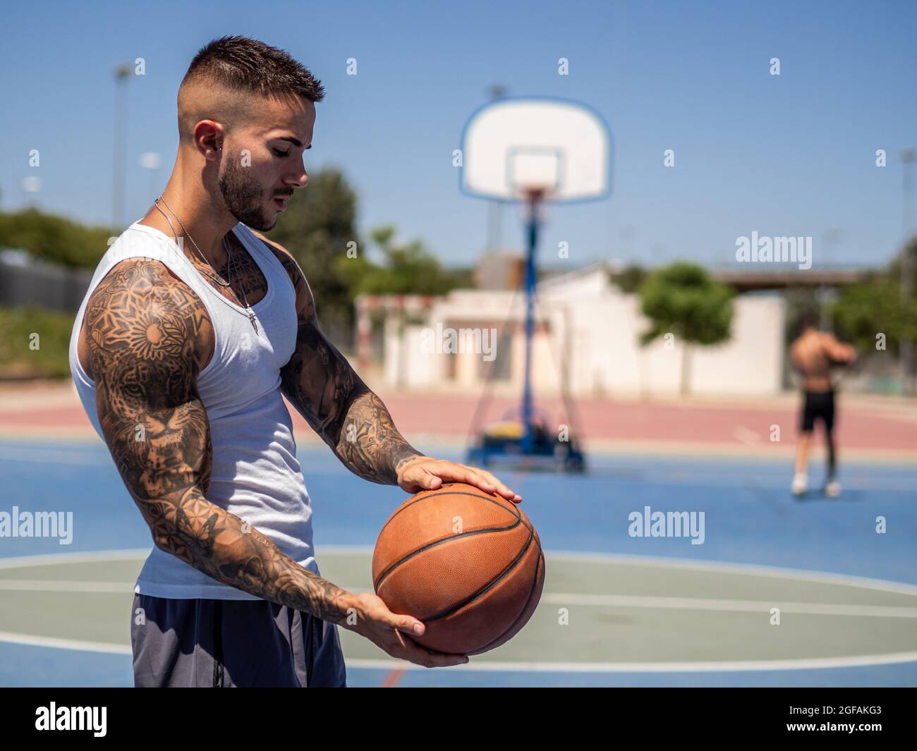 Athletic handsome Spanish basketball player training on basketball ...