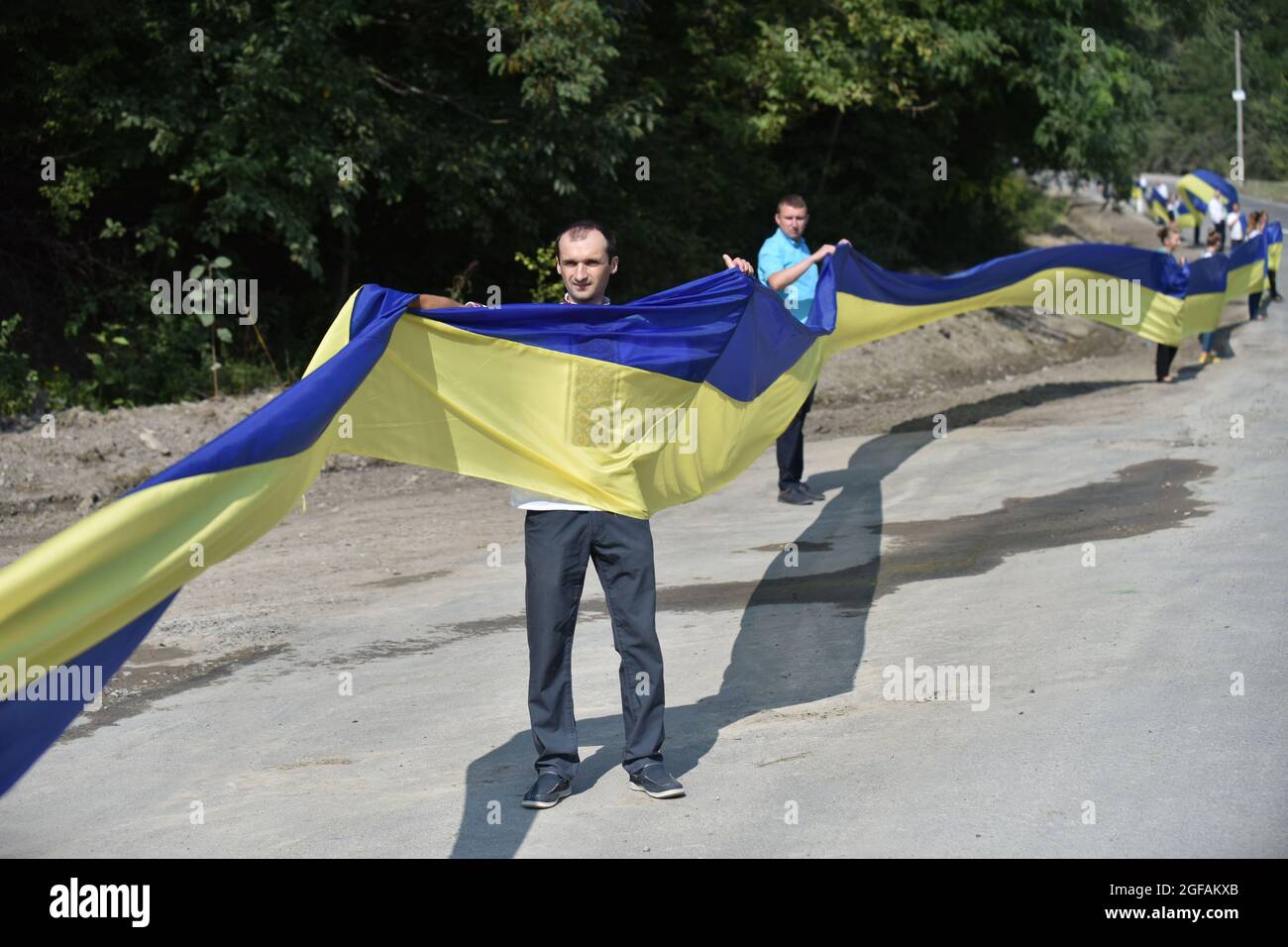 People hold the flag of Ukraine during the setting of the record for ...