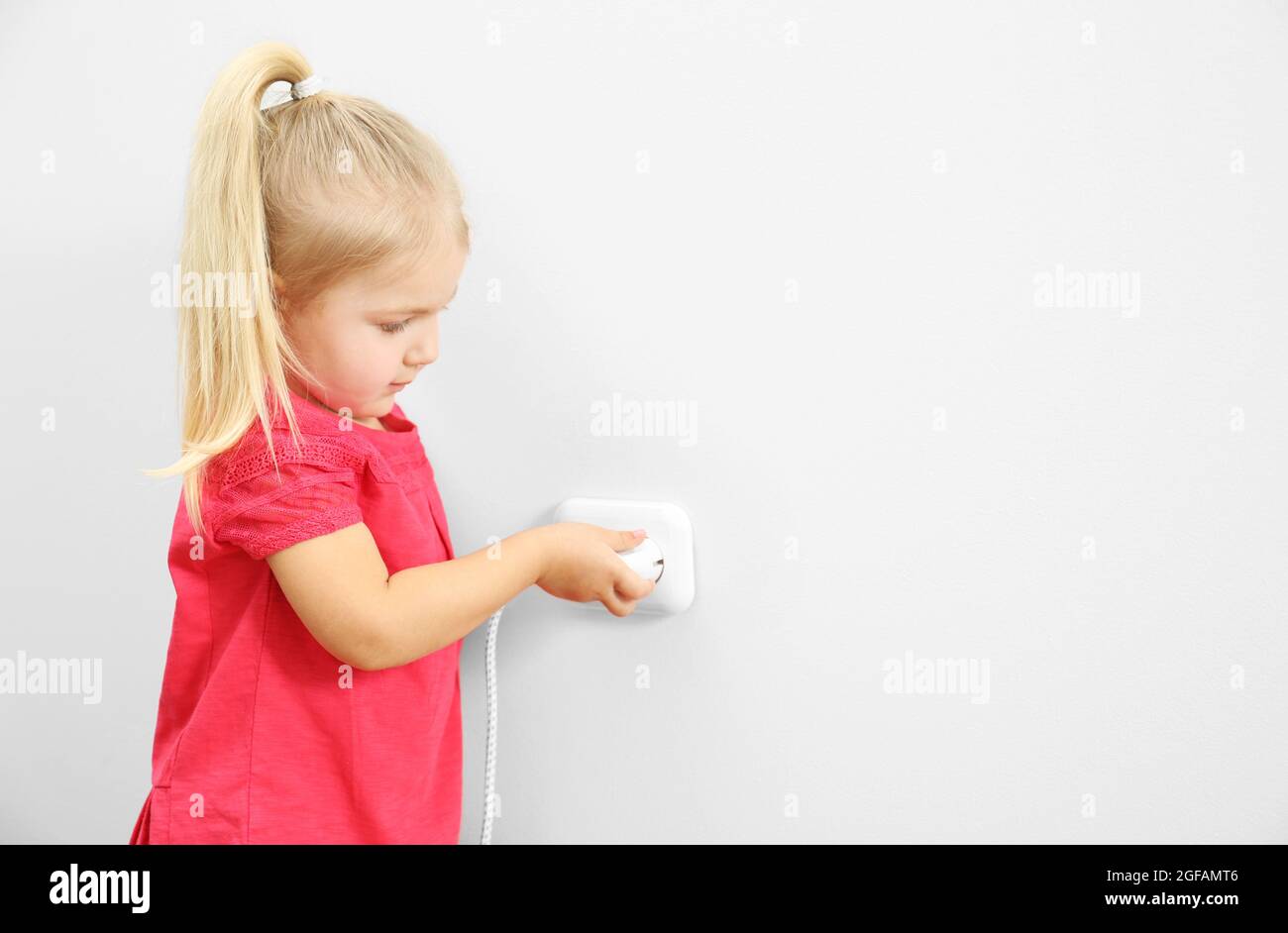 Little child putting plug in power socket Stock Photo - Alamy