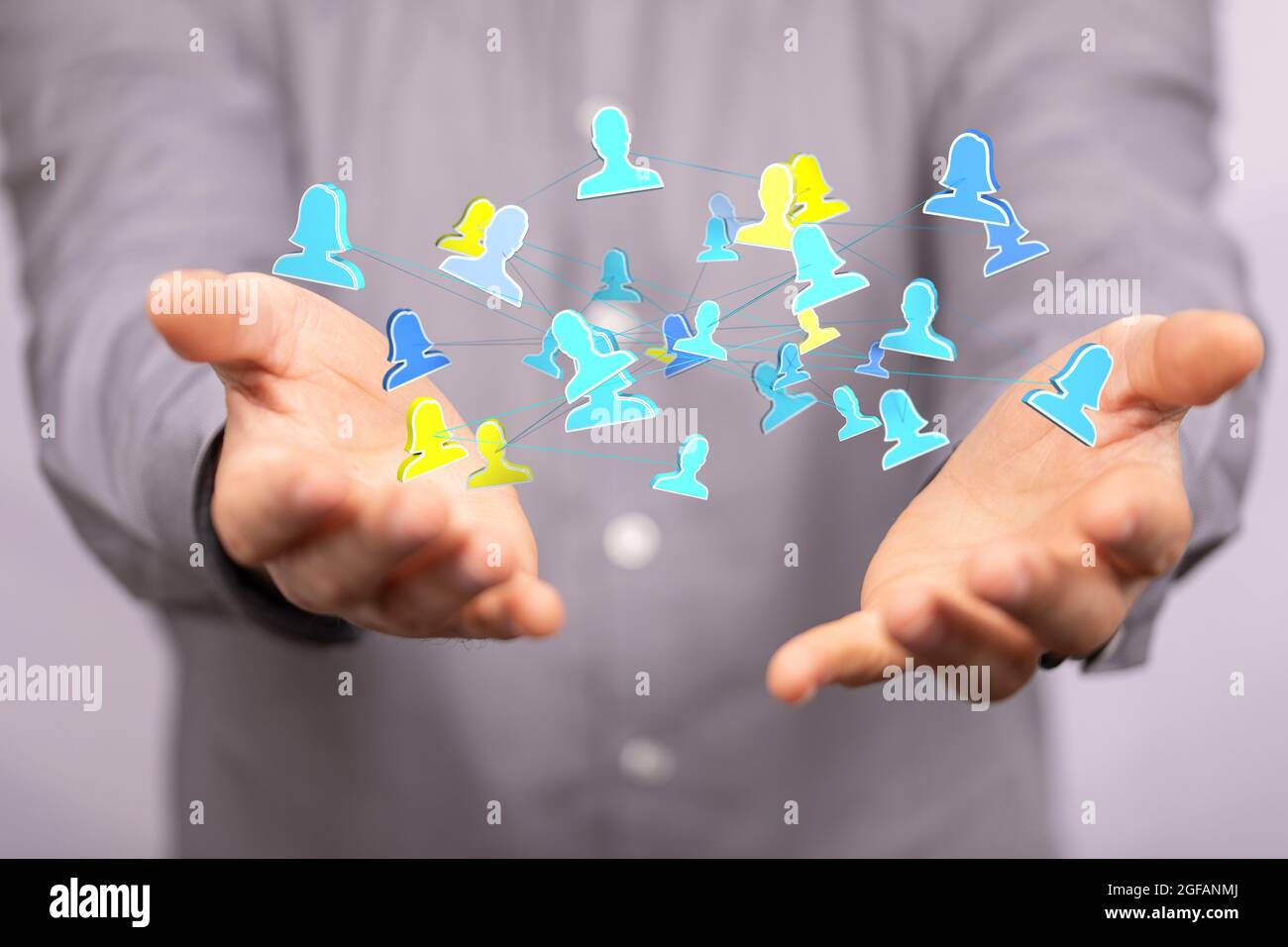 Male's hands holding an illustration of a videoconference group of ...