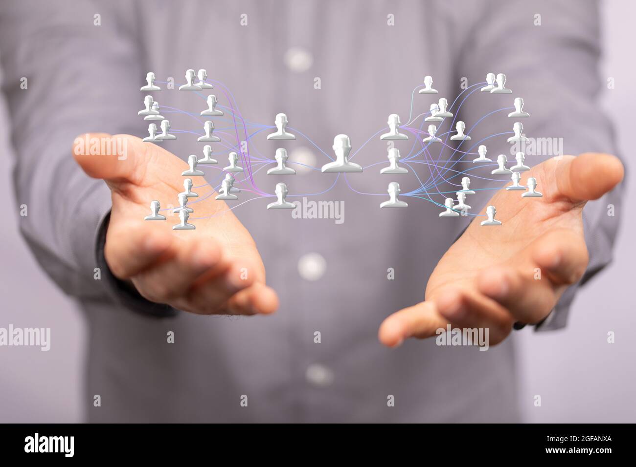 Male's hand holding an illustration of unity group and teamwork concept ...