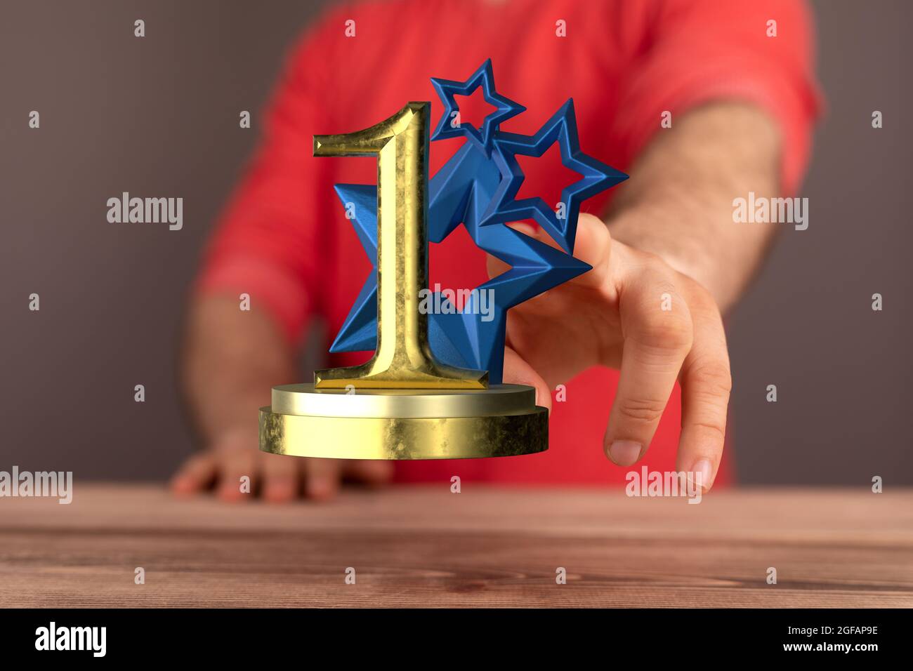 Male's hand holding an illustration of a first place prize gold medal ...