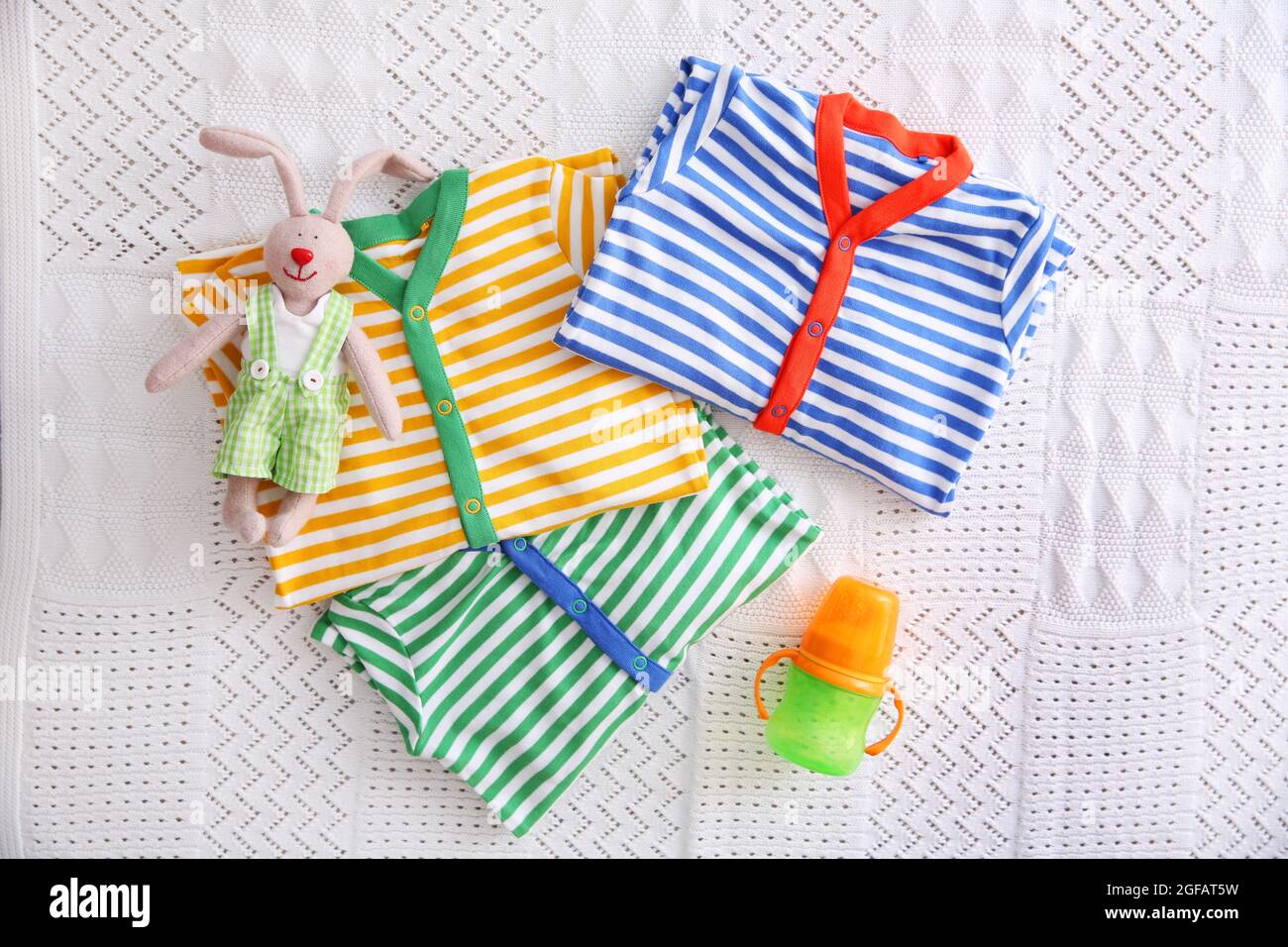 Baby clothes on fabric background Stock Photo - Alamy