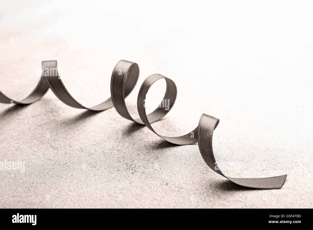 Grey ribbon on light textured background Stock Photo - Alamy