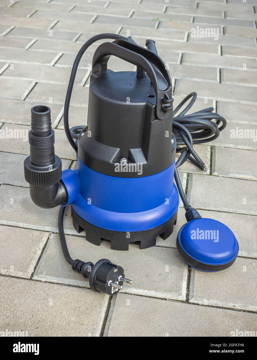 New low-power submersible pump with a blue plastic housing on a stone ...