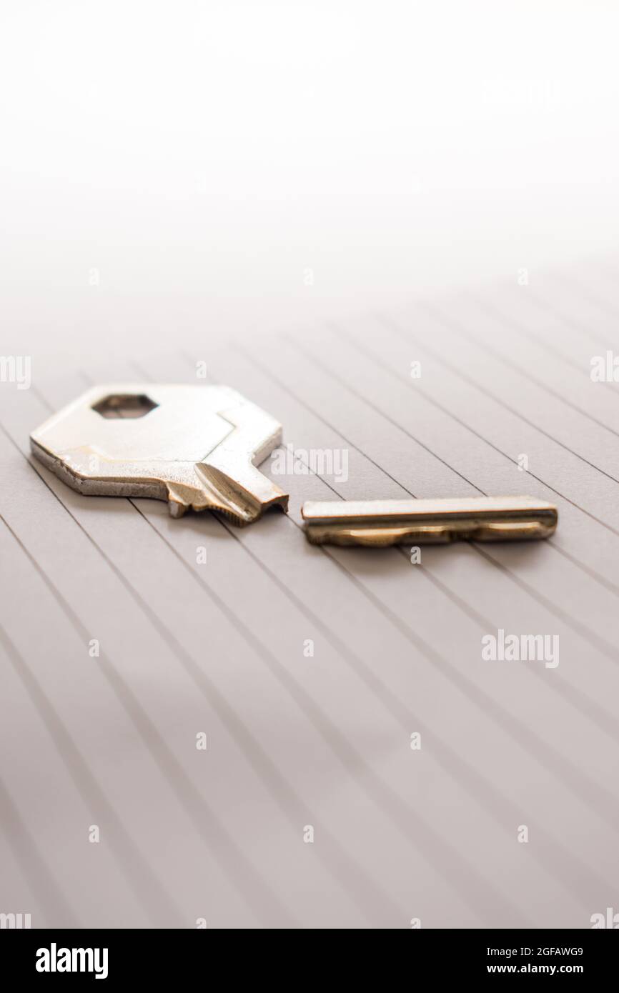 Broken metal key on a white background with copy space Stock Photo - Alamy