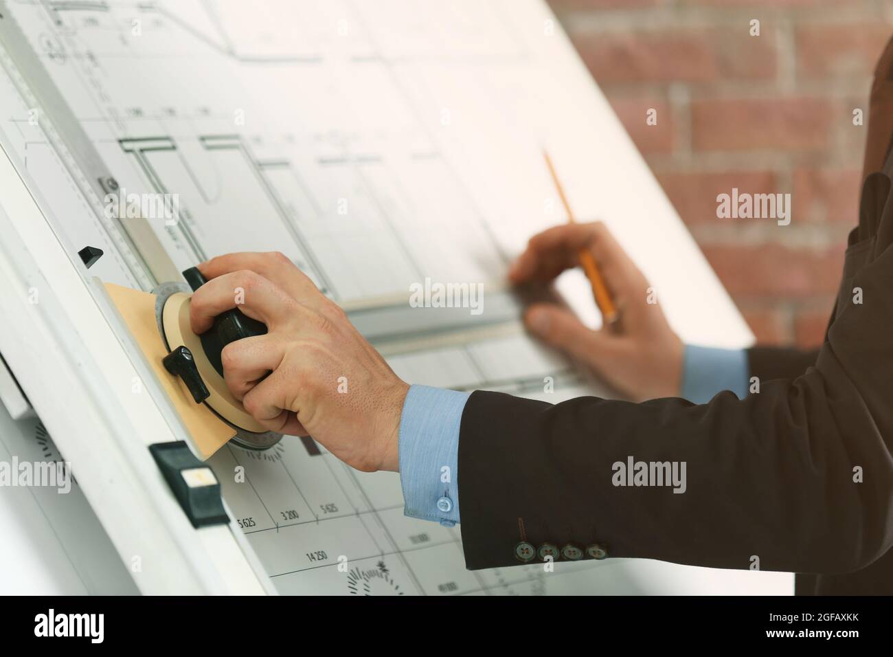 Engineer working with blueprint on panel board indoors Stock Photo - Alamy