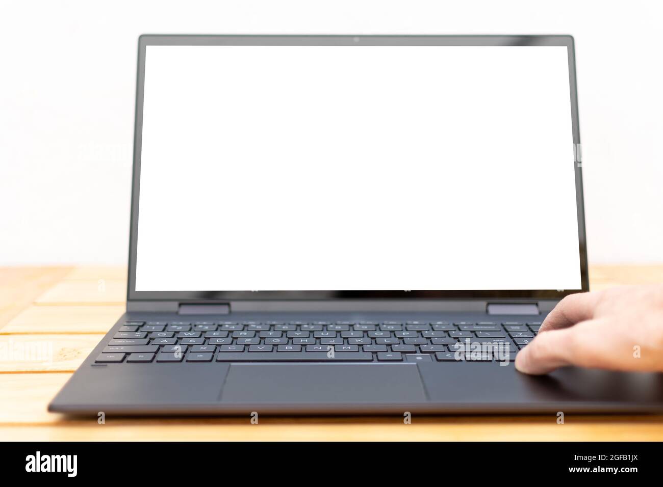 Hand operating the numeric keypad of a laptop with the blank screen ...