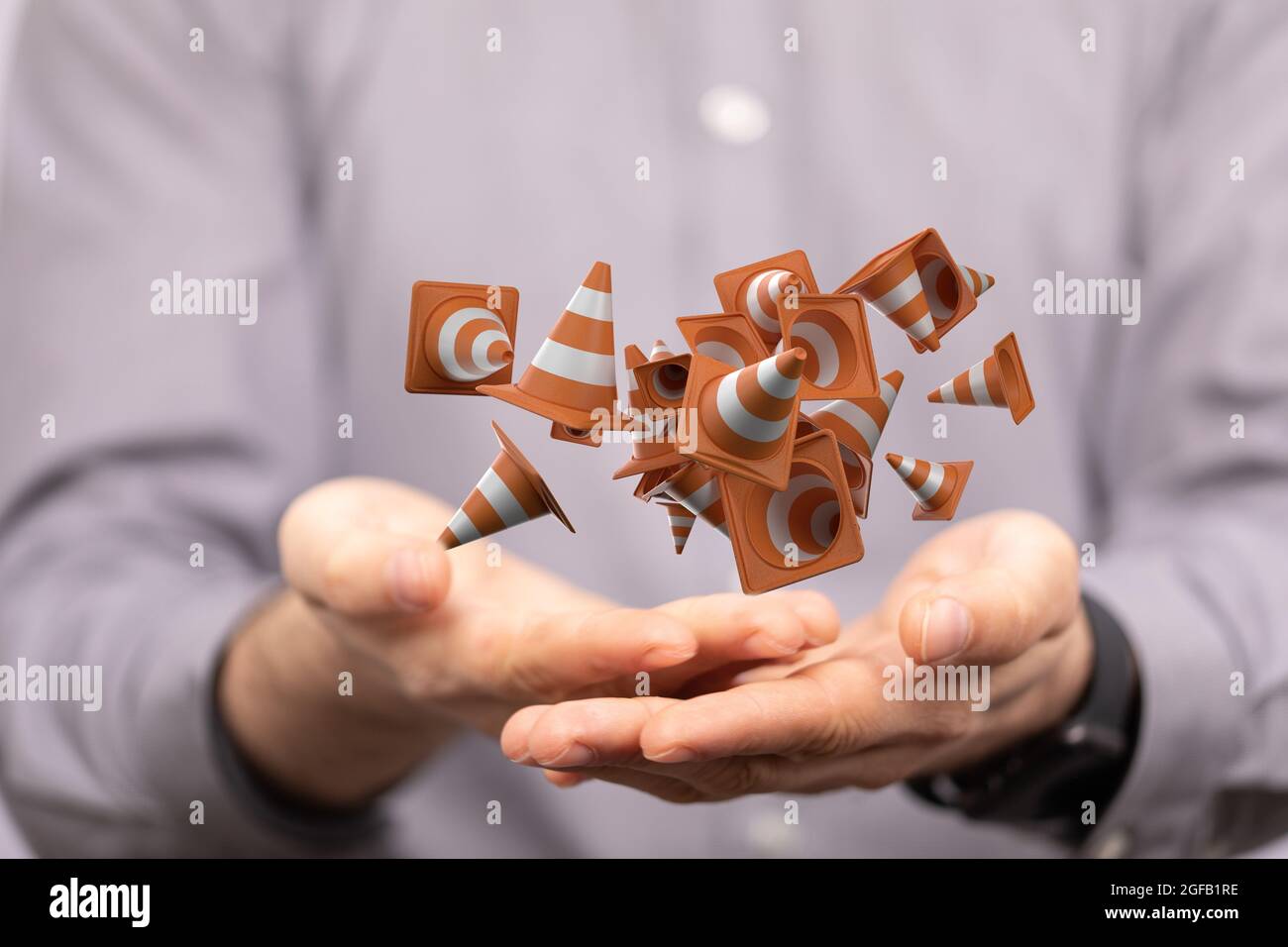 Pair of hands holding a render of floating traffic cones- website under ...