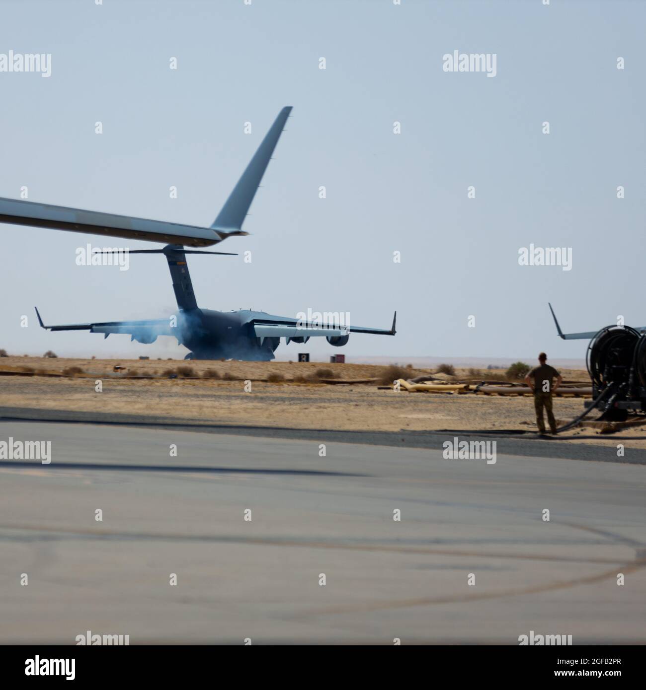 A U.S. Air Force C-17 lands while transporting the first group of ...