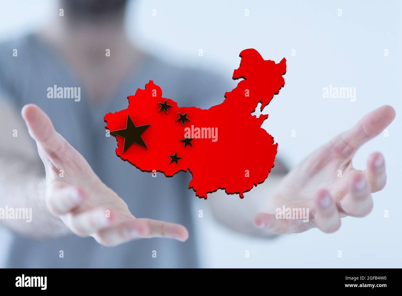 Pair of hands holding a render of the outline of China with the flag ...