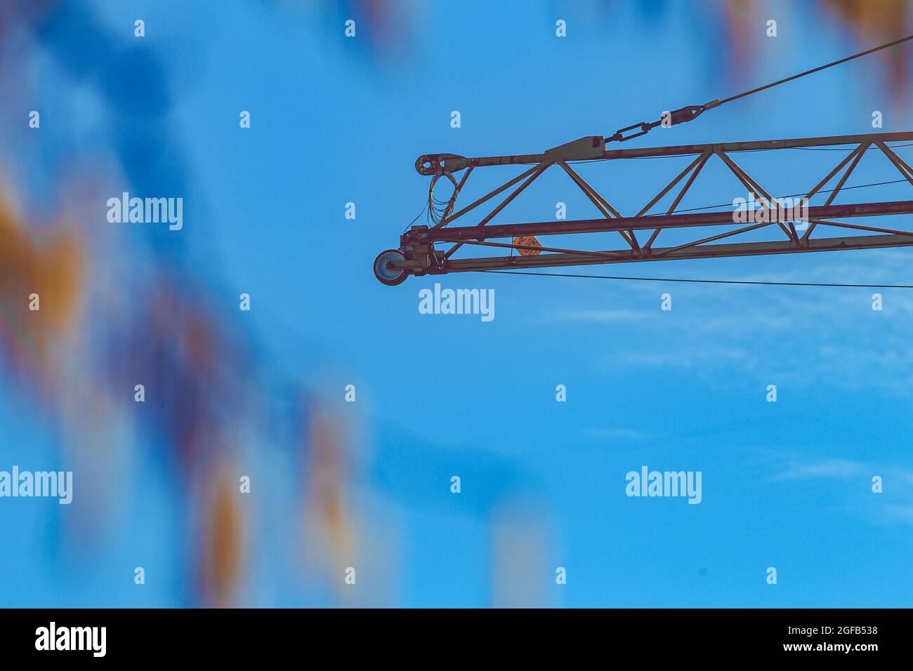 View of boom of a construction crane against blue blurred background ...