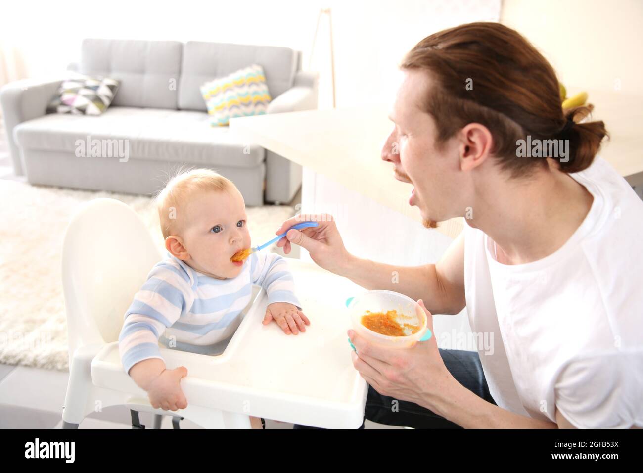 Father feeding his baby son Stock Photo - Alamy