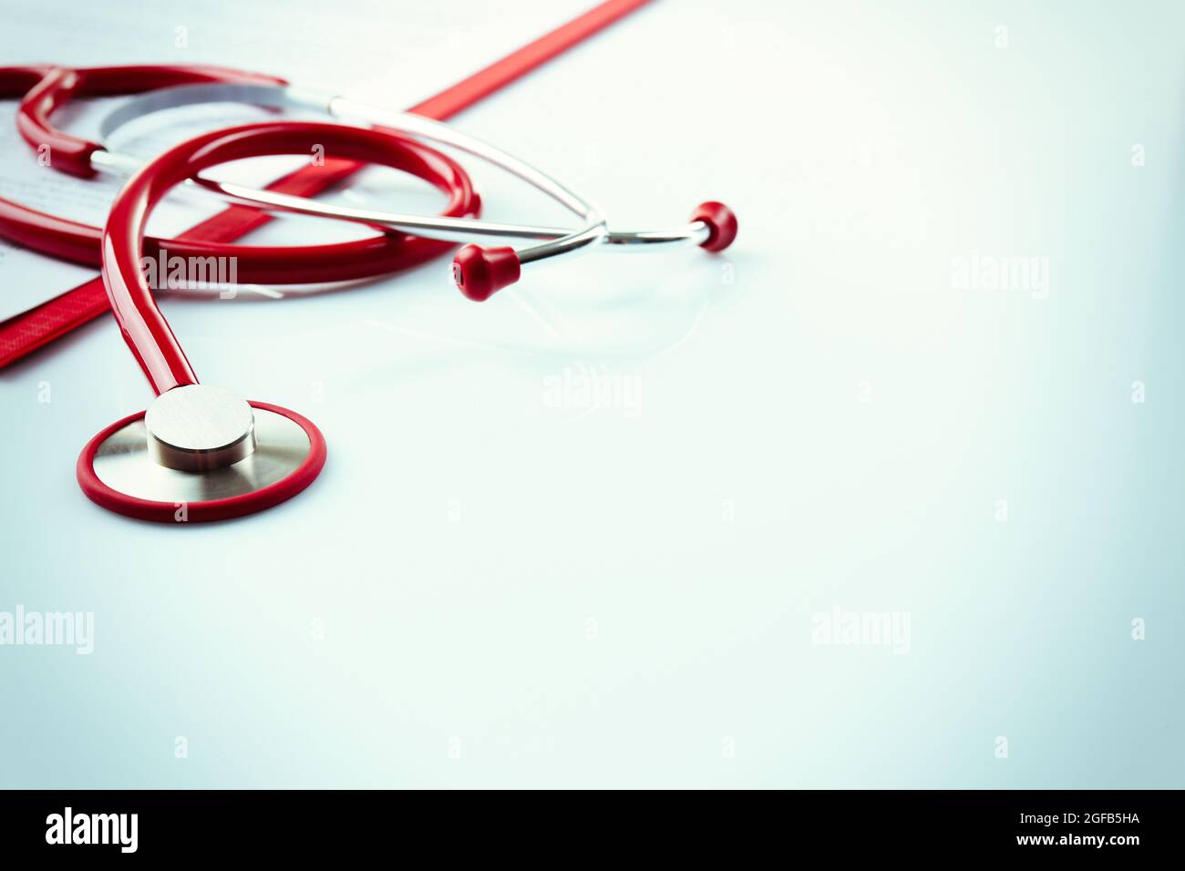 Red stethoscope and prescription isolated on white Stock Photo - Alamy