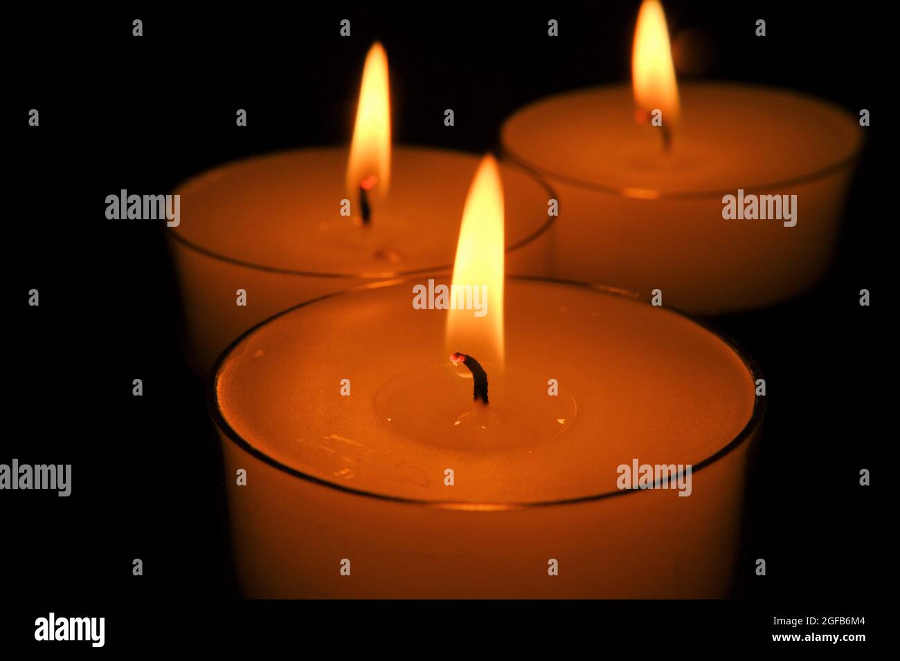 Candle flame. white candles Set. Burning candles in the dark.Close-up ... Candle flame. white candles Set. Burning candles in the dark.Close-up ...