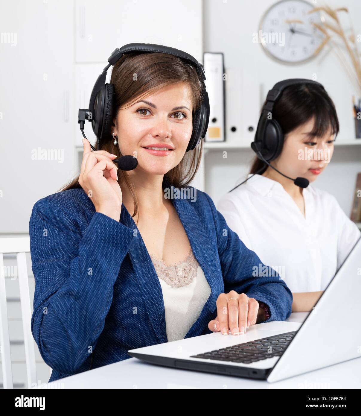 Sales assistants working with computers in an office Stock Photo - Alamy