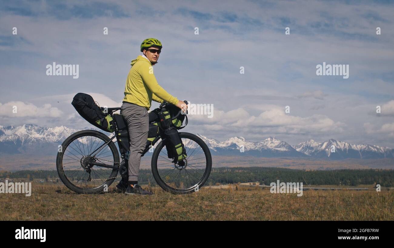 The man travel on mixed terrain cycle touring with bikepacking. The ...