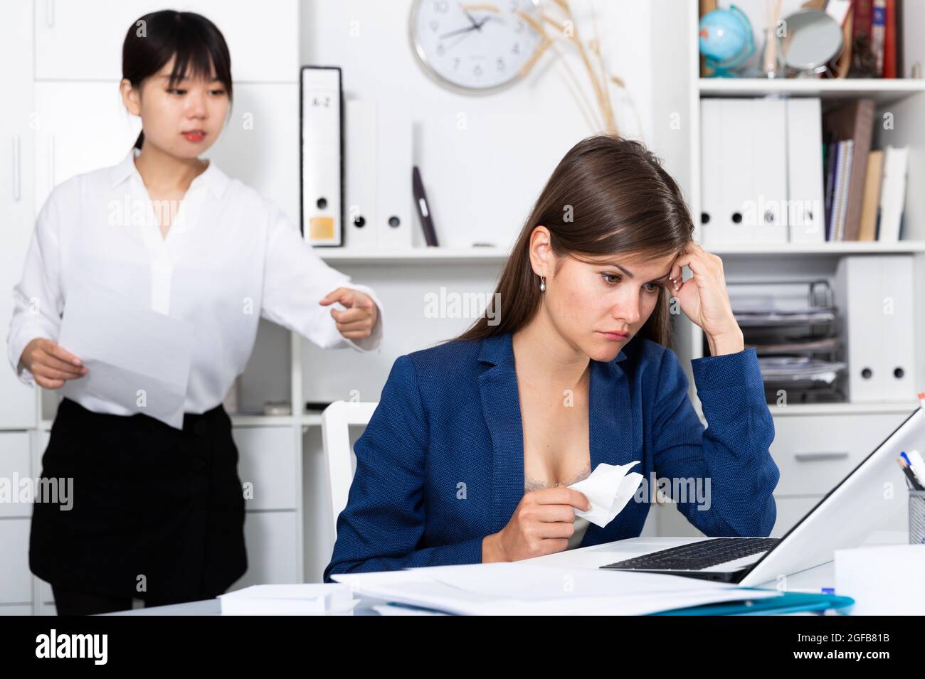 Upset woman with angry boss Stock Photo - Alamy
