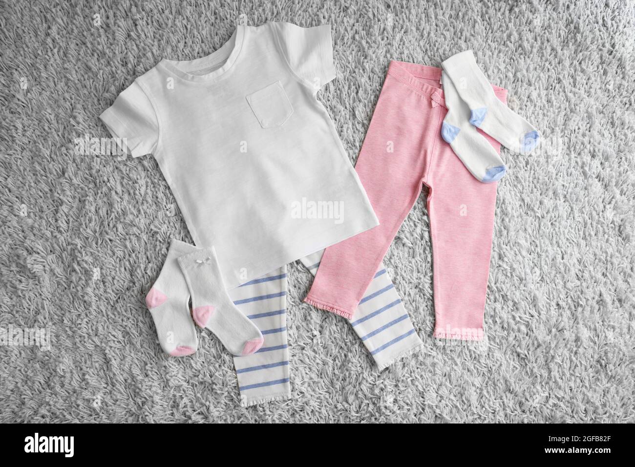 Child clothes on light background Stock Photo - Alamy