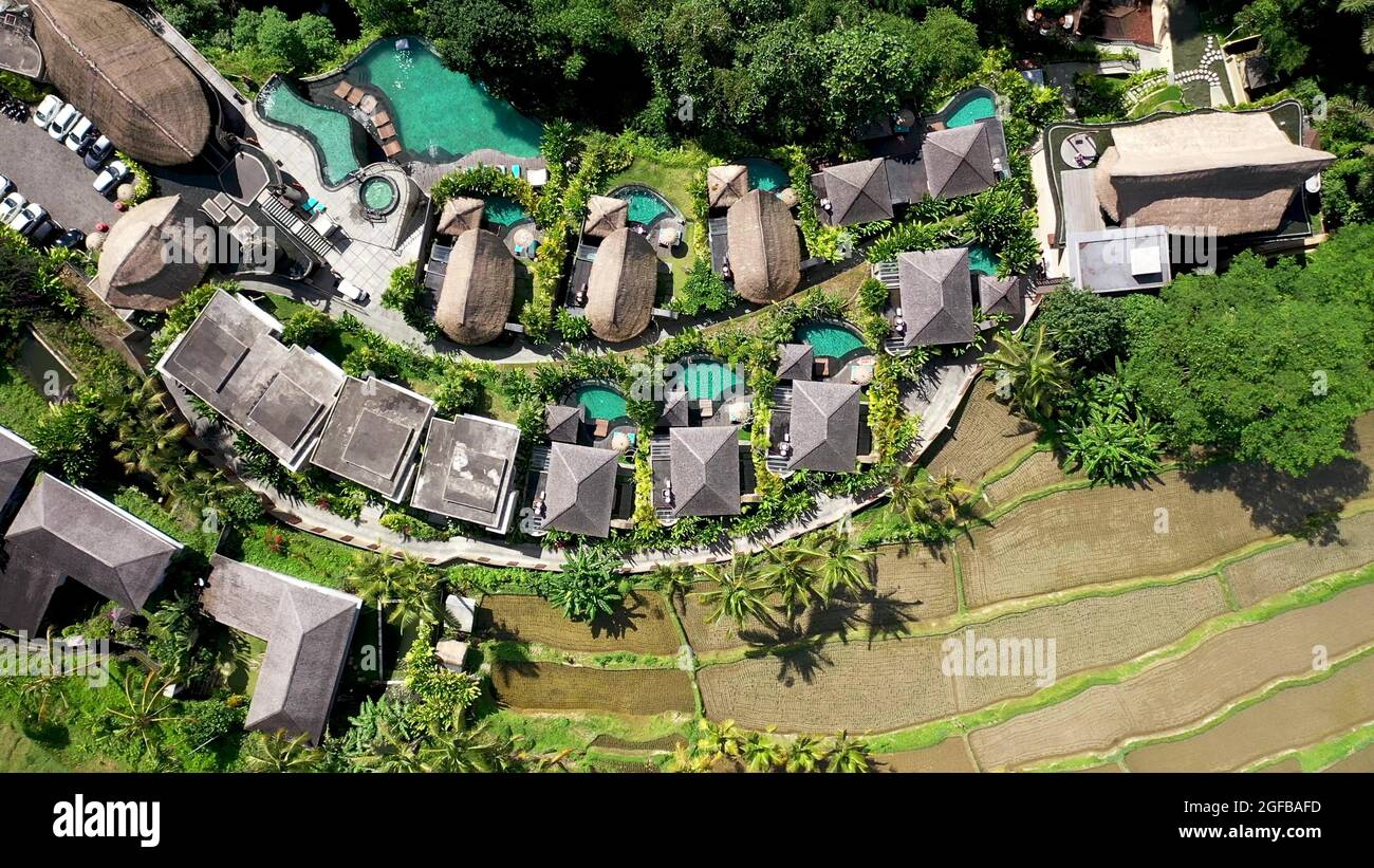 Aerial top down view of beautiful resort with swimming pool and hut ...