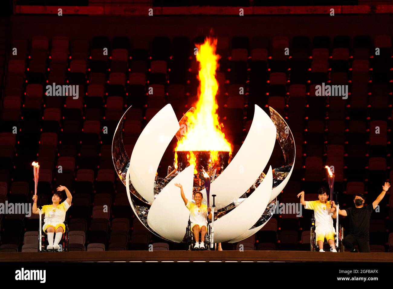 (L-R) Karin Morisaki, Yui Kamiji, Shunsuke Uchida light the Paralympic ...
