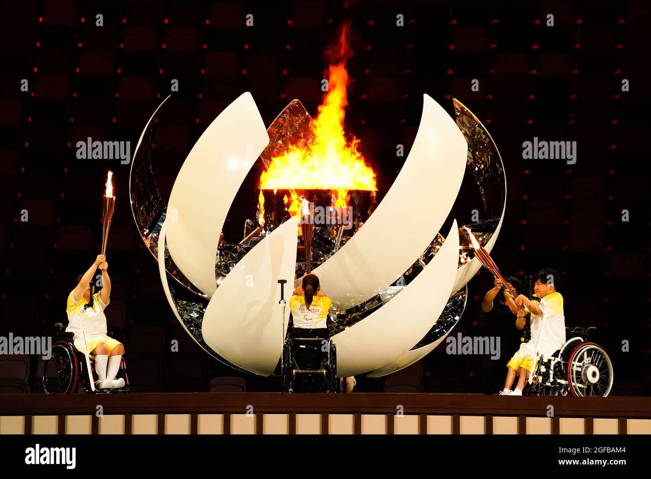 (L-R) Karin Morisaki, Yui Kamiji, Shunsuke Uchida light the Paralympic ...