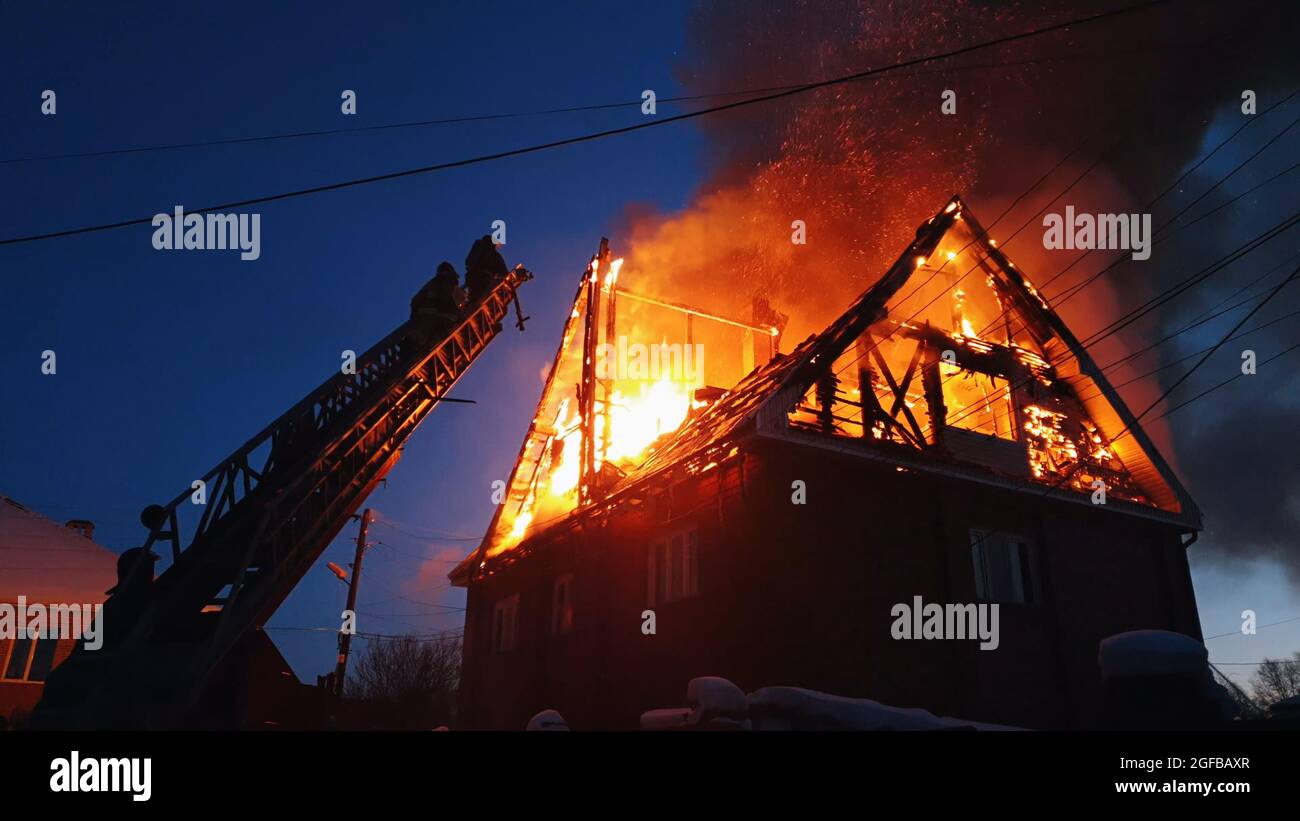 The roof of the house is on fire. The residential building burn ...