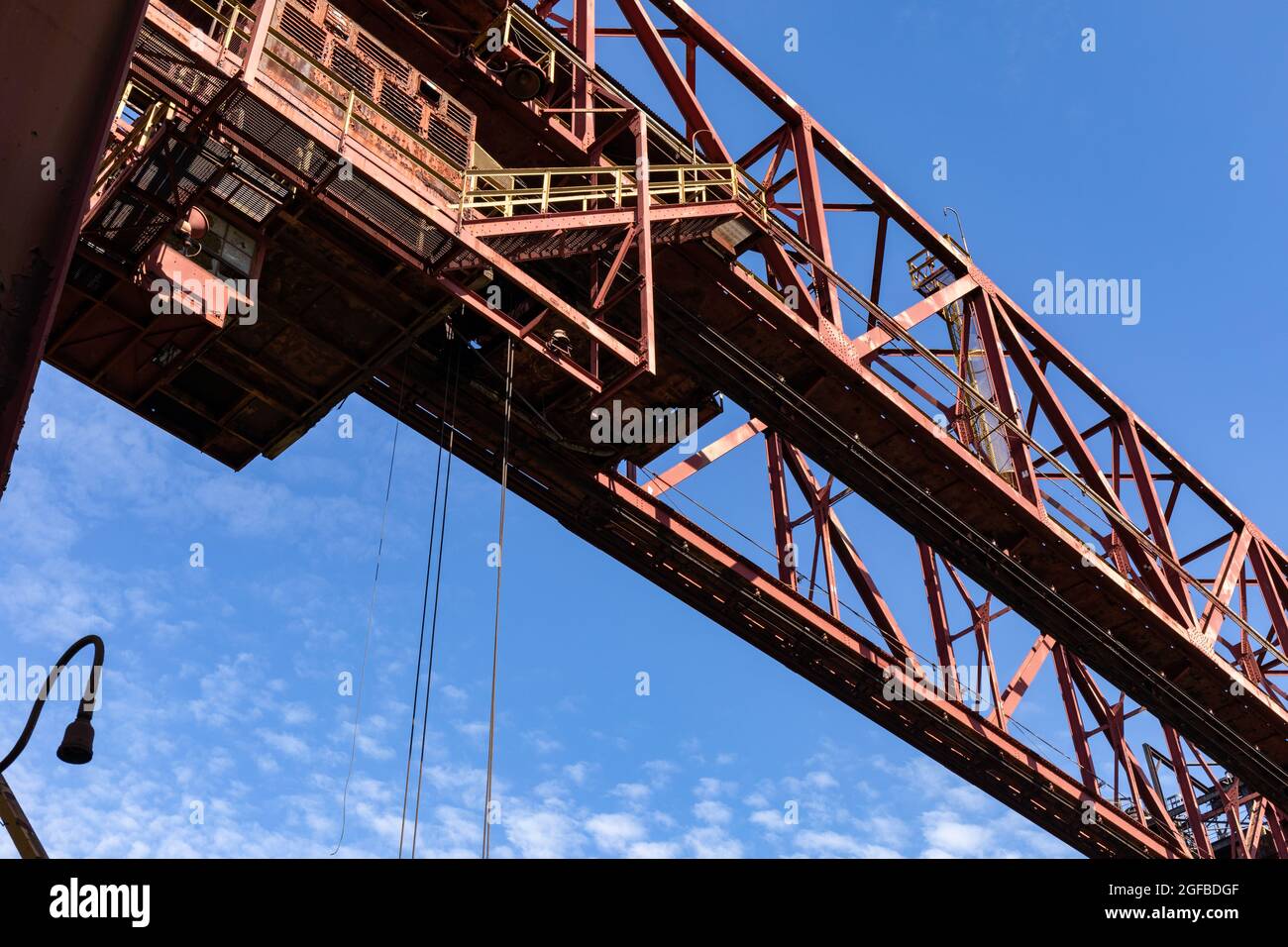 Massive overhead industrial structure with open stairs and open grates ...
