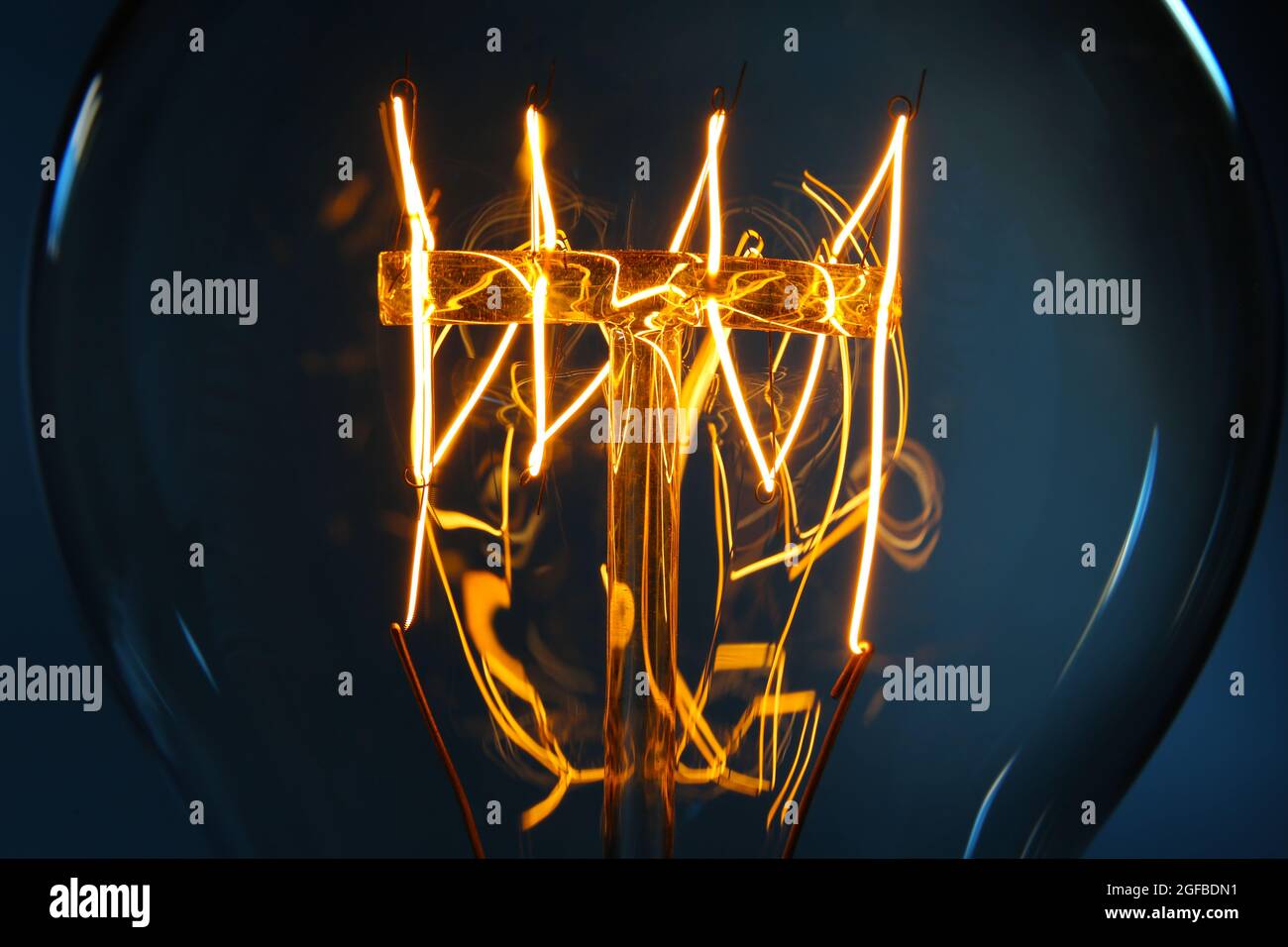 Illuminated light bulb on dark blue background Stock Photo - Alamy