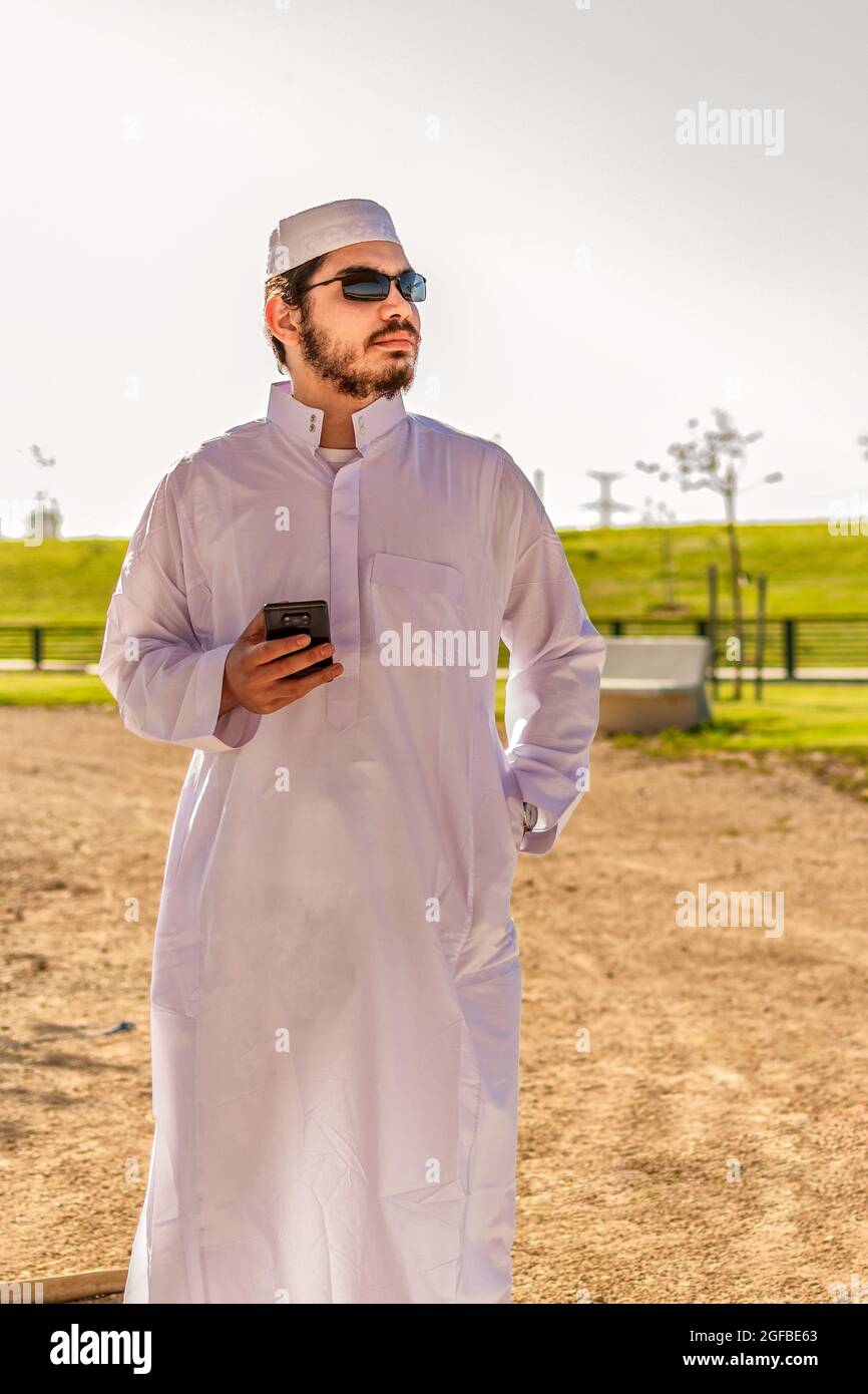 Vertical shot of a Saudi Arabian man with sunglasses and traditional ...