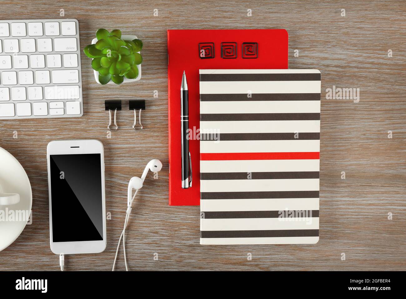 Keyboard, phone, notebook on a wooden desk background, top view Stock ...