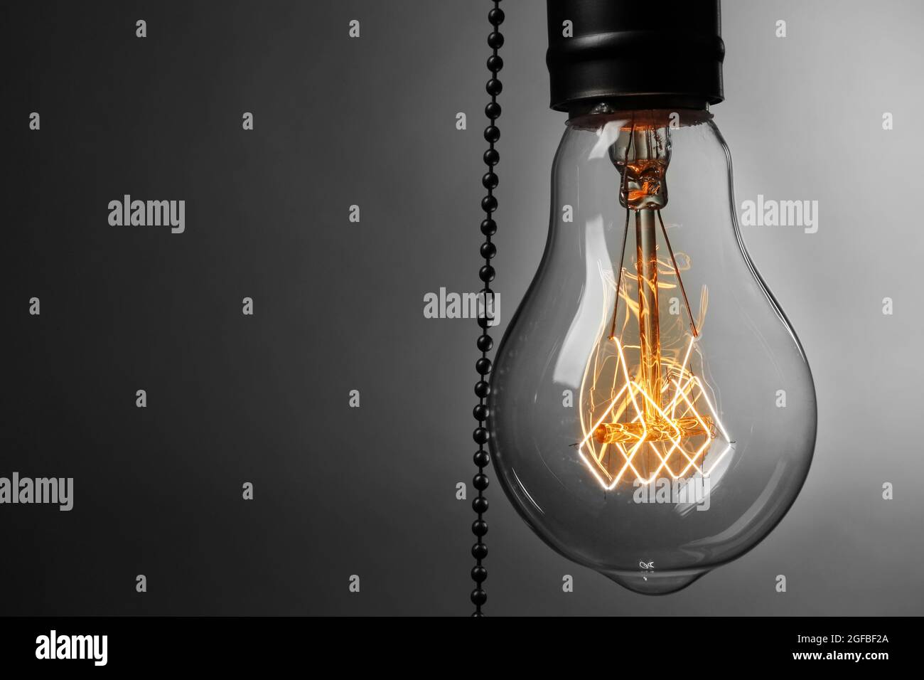 Light bulb on grey background Stock Photo - Alamy
