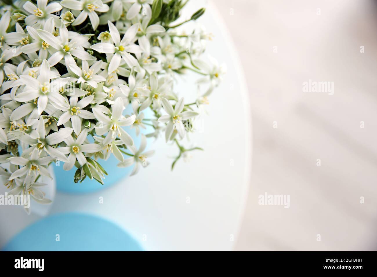 Bouquet of little white flowers on light background Stock Photo - Alamy